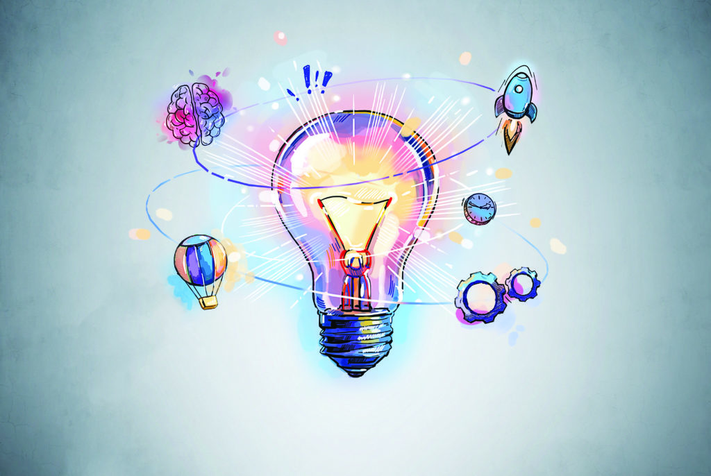 Businessman hand drawing colorful light bulb as a concept of new idea ...